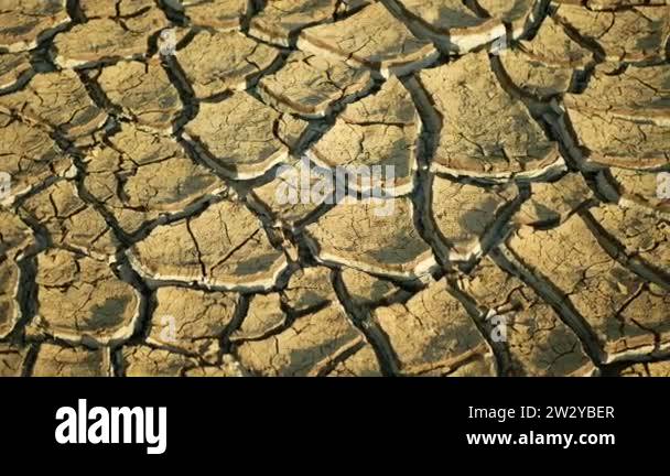 Drought cracked lake pond wetland clay drying up the soil crust earth ...