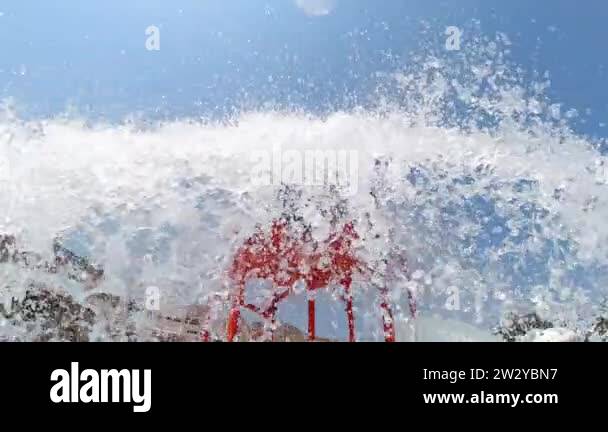 Spray of pouring water in slow motion on the slides in water park. Aqua ...