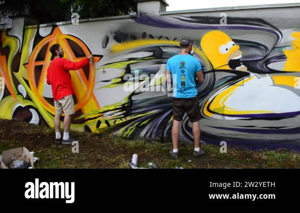 Process of creation of graffiti, fence. The artist draws graffiti Stock ...