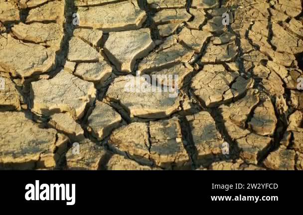 Drought cracks lake pond wetland clay drying up the soil crust earth ...