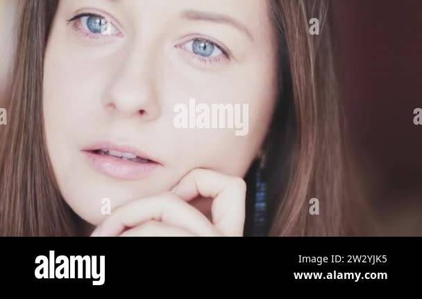 Calm woman daydreaming and looking aside, authentic face portrait with ...