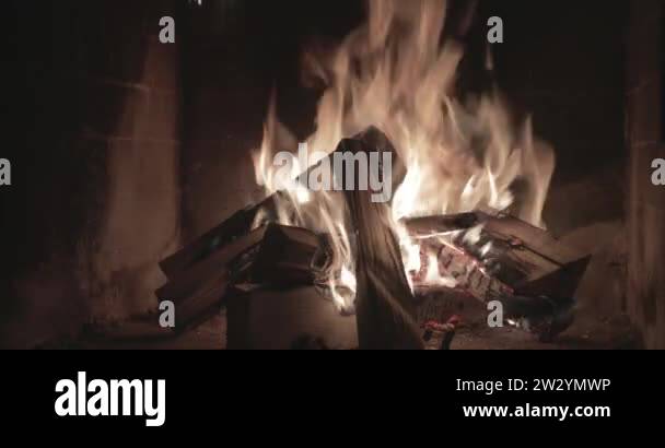 The big fire with firewood in a fireplace, bonfire burning, Brick walls ...