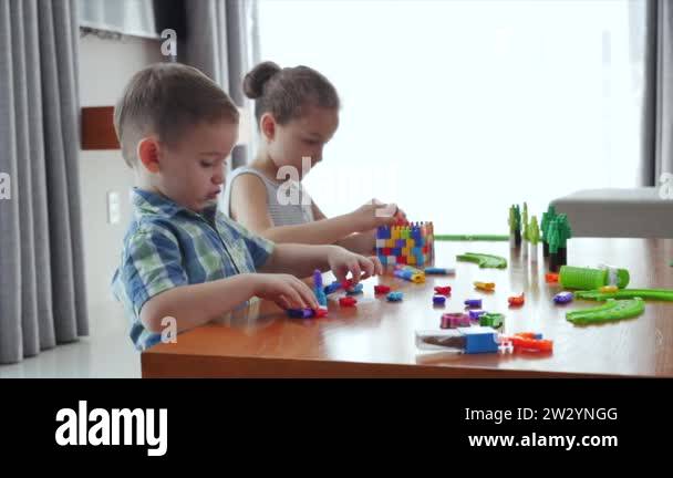 Happy family, a daughter and a son, two small children at home sit at a ...