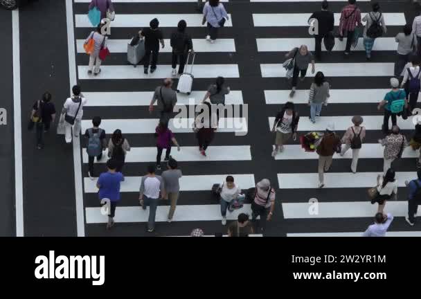 Slow motion aerial of crowd of people locals and tourists walking in ...
