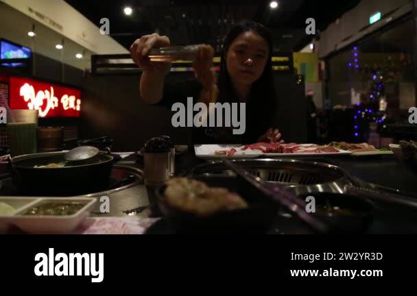 Asian girl happy making delicious food BBQ chinese meat in Taiwan in ...