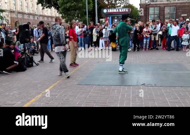 Young boys and girls are dancing on the street break dance among crowd ...