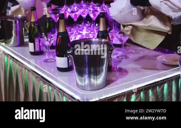 Glasses with alcoholic beverages in the pyramid, filling and pouring ...