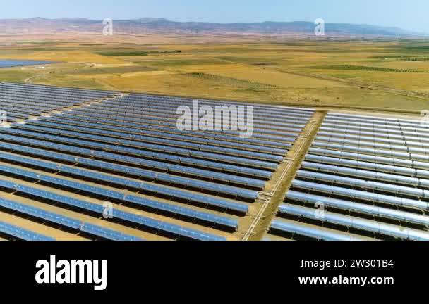 Aerial view of a farm of solar panels (solar cell) with its factory ...