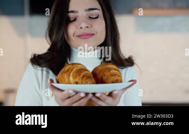 Young funny woman smeared her face with flour while cooking. She does ...