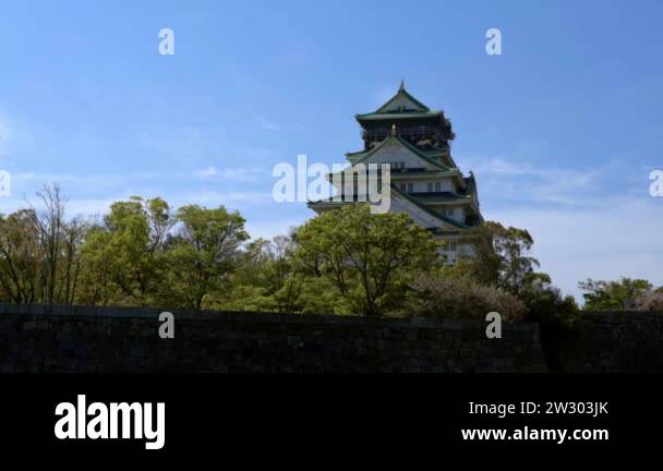 4K, Main tower of Osaka Japanese Castle behind rock wall, famous ...
