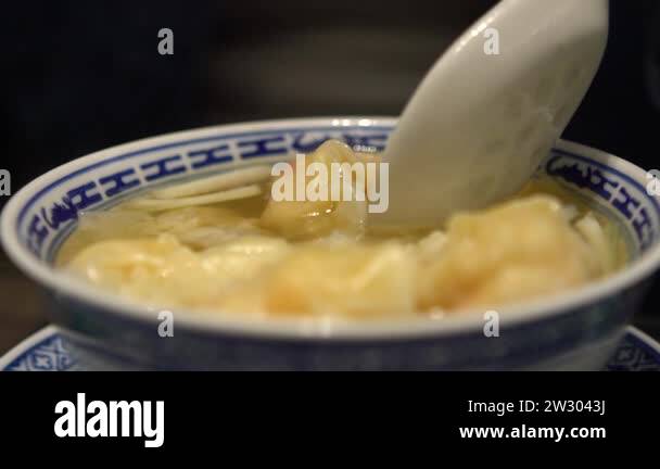 Slow motion people eating a dumpling of prawn for dinner in an asian ...