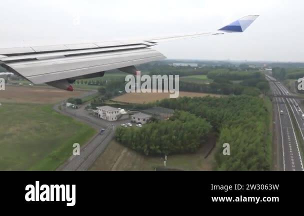 4K Airplane landing at international Airport as seen through an ...