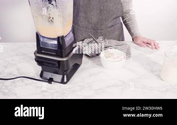 Mixing ingredient in an electric blender to make the crepes batter ...