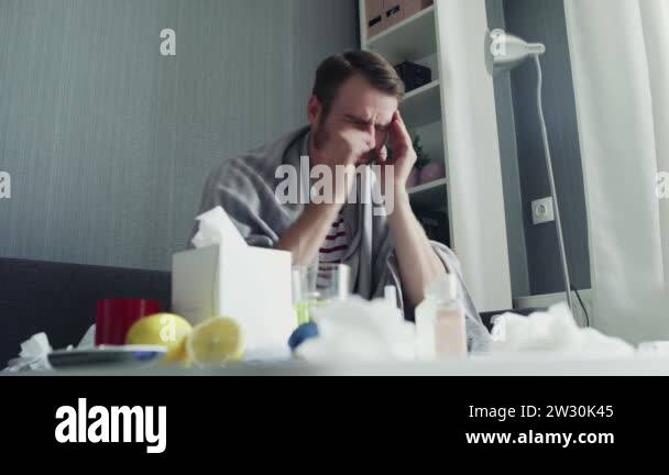 Sick man is suffering from severe headache touching his head massaging ...