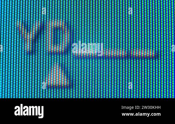 Pixels in the working old analog TV screen close up. Red, blue and ...