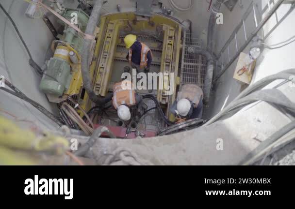 Men at Heavy Industry engineers site working Inside concrete pipe tube ...