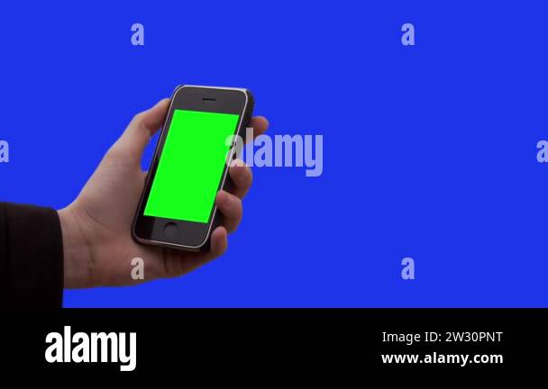 Male Hand using an Old Smartphone with Green Screen over a Blue ...
