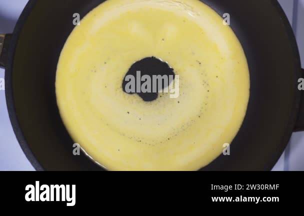 Emoticon made from butter, reverse video. Smiley is melted in a skillet ...