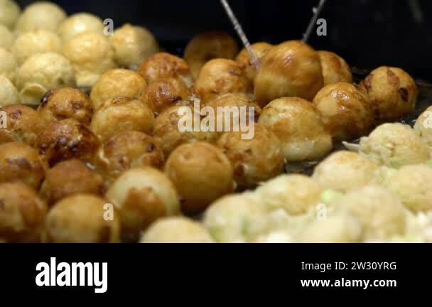 Slow Motion Japanese vendor prepare a Takoyaki on hot pan food Japan ...