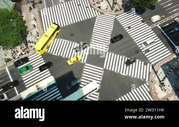 Tokyo - Aerial view of junction with traffic and people on crosswalk. 4K resolution time lapse ...