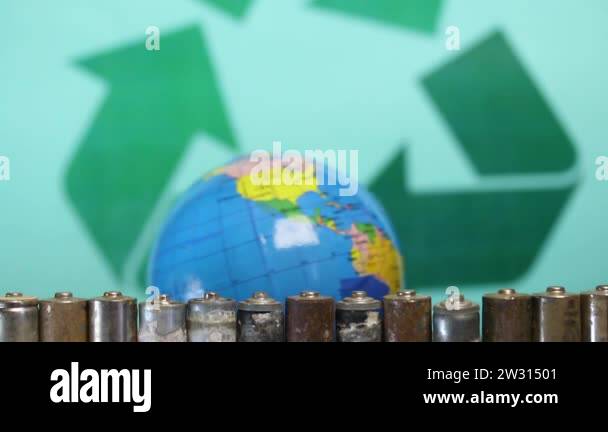 Rotating globe on the background of the sign of waste recycling. In ...