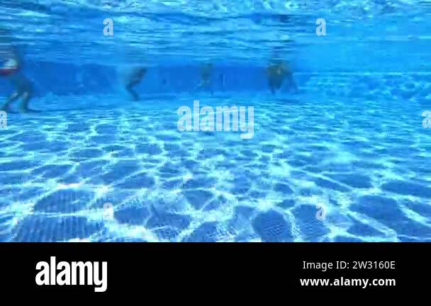 People swimming in the swimming pool. Underwater video of children's ...