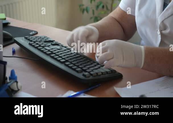 Medicine female worker sitting, printing on a computer keyboard in ...