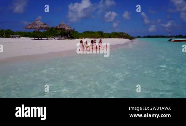 video the tan girls in bikini lying on the white sandy beach and ...