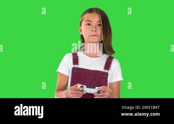 Little girl gamer playing video game on a Green Screen, Chroma Key ...