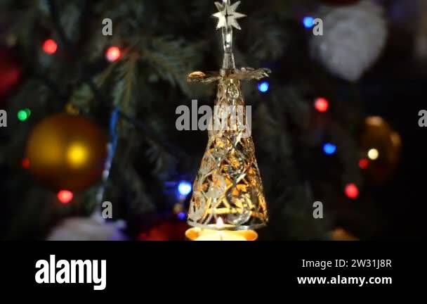 Decorative toy in shape of Christmas tree rotates in circle from energy ...