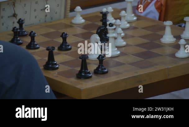 Two Men Are Sitting in Front of Each Other on The Bench, Playing Chess ...