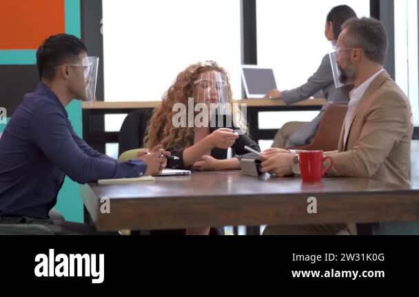 business senior man and woman with face shield talking at conference ...