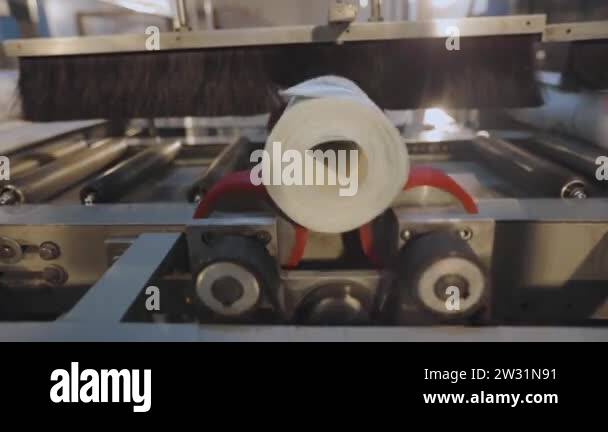 A roll of wallpaper on a conveyor line. Roll of wallpaper. Conveyor ...