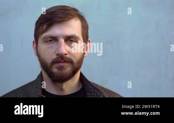 Handsome young Caucasian man with thick heavy beard, freckles in black ...