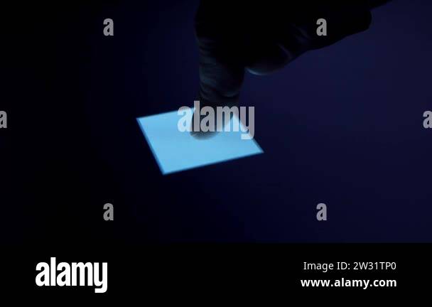 Human finger is pressing a digital button on a glowing touchscreen ...