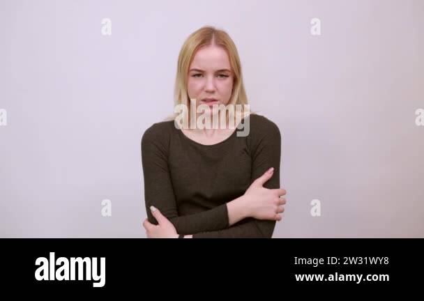 Confused Girl Clasped Hands To Her Chest, Holds Them Crosswise Stock ...