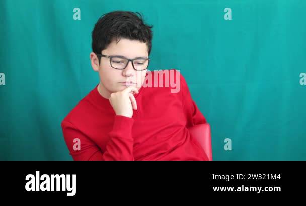 Young handsome teenage boy thinking gainst chroma key green screen ...