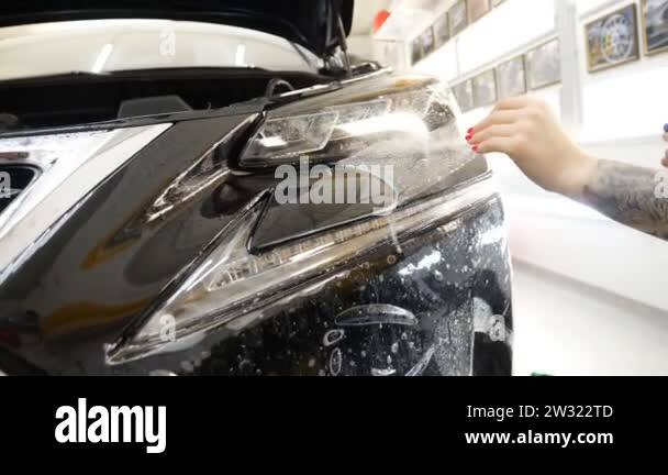Close up to PPF installation process on a front rear headlight and ...