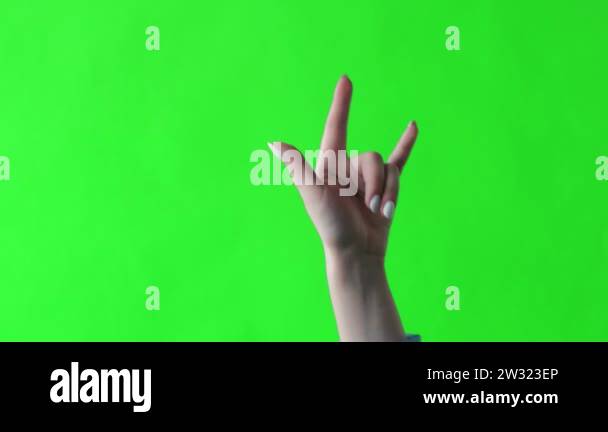 Sign of the horns with fingers on green screen. Simbol of heavy metal ...