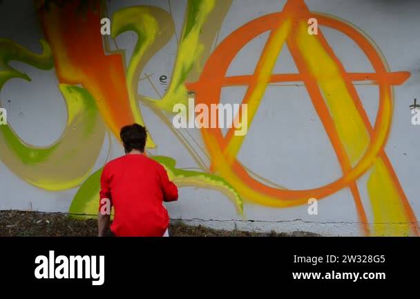 Process of creation of graffiti, fence. The artist draws graffiti Stock ...