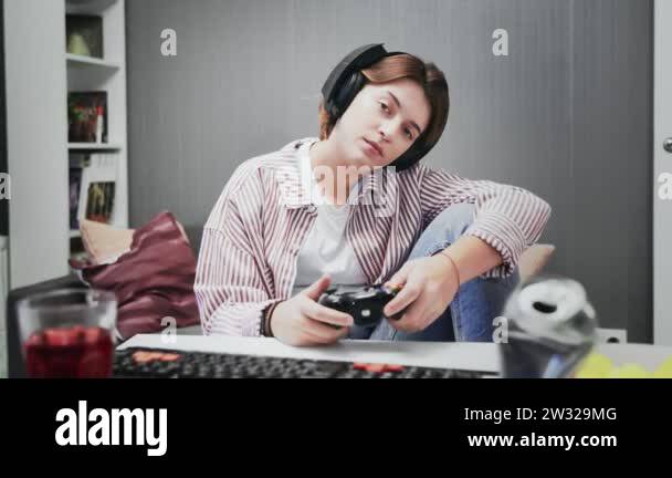 Boring Young Gamer Girl playing in Video Games on a Console with a ...