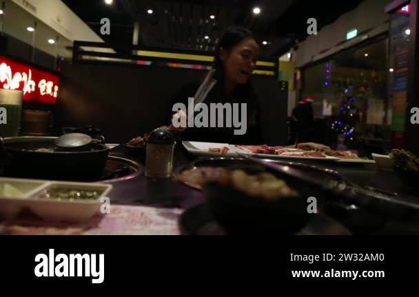 Asian girl happy making delicious food BBQ chinese meat in Taiwan in ...