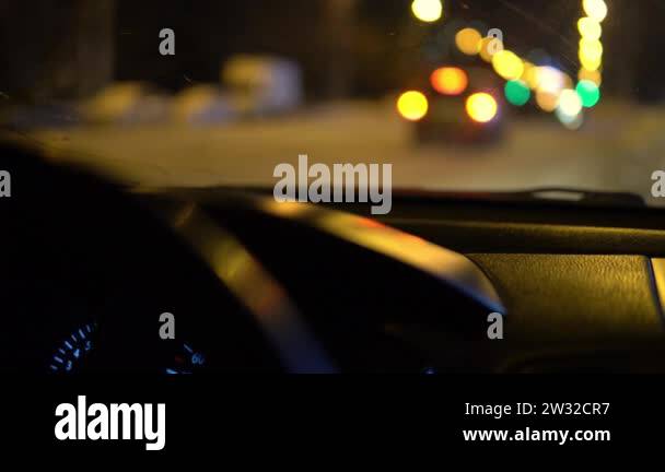 Close-up view from behind the wheel of a car, cars drive behind the ...