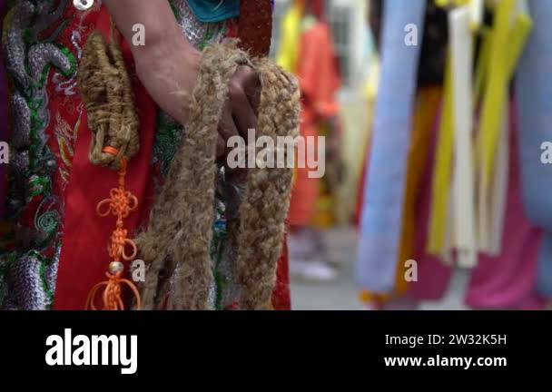 4K A guard of Guan Jiang Shou hold a big rope in the hand. Procession ...