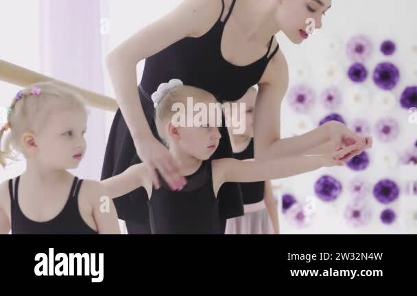 Children and teacher at the ballet school. Lesson of classical ballet ...