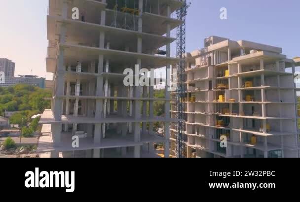 Construction of a multi-storey residential building aerial view. Span near the construction site ...