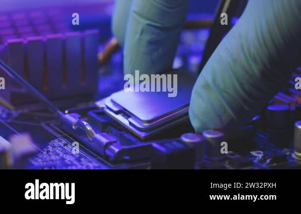 High Tech Factory Facility. Build computer concept. The technician installing the CPU in the ...