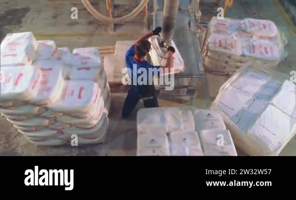 Loading bags onto a conveyor belt. Vacuum manipulator lifting bags on a ...