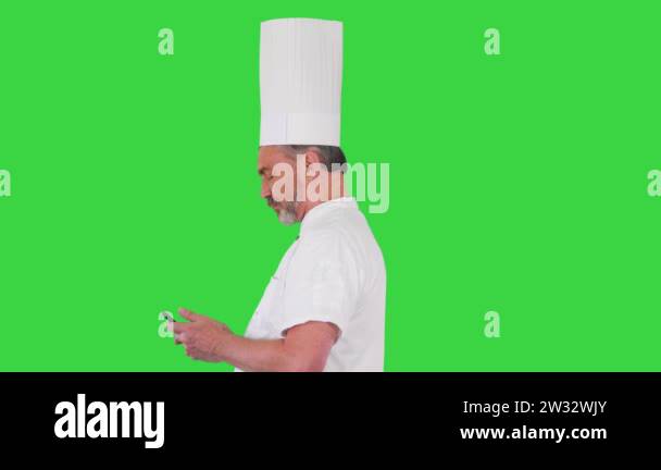 Senior chef in uniform using mobile phone on a Green Screen, Chroma Key ...