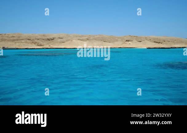 Sandy cliffs and clear blue waters rich in coral reefs of Giftun island ...